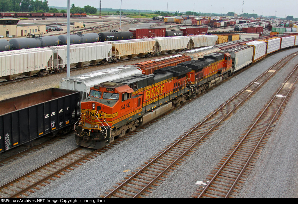 BNSF 4440 rolls in a freight train into the yard with a freight.